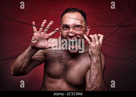 Image of tangled in black threads man Stock Photo - Alamy