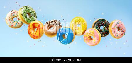 Various decorated doughnuts in motion falling Sweet and colourful ...