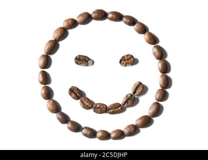 Happy emoticon made of coffee beans on a yellow background Stock Photo ...