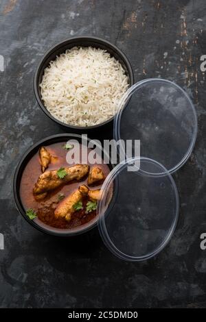 Indian Red Chicken curry packed for home delivery in plastic container ...