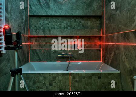 Laser measurement during bathroom renovation Stock Photo - Alamy