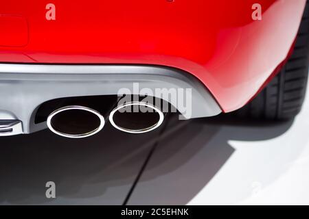 Close up of a car dual exhaust pipe. Double exhaust pipes of a red ...