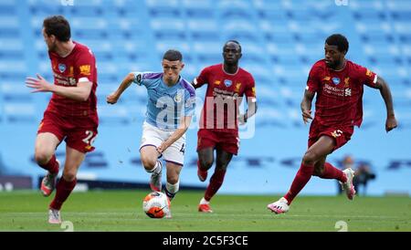 Phil Foden of Manchester City controls the ball under pressure from ...