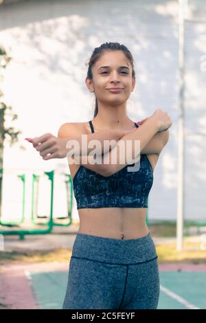 Mexican fitness girl stretching outdoors Stock Photo - Alamy