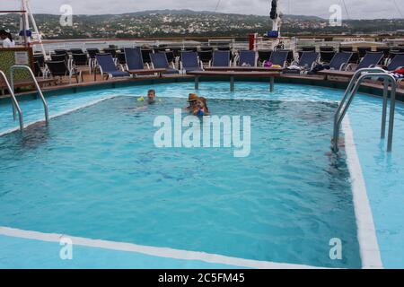 Cruise ship's pool for vacationers on their cruise, having fun at sea ...