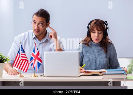 Young woman with earphones and book pointing at something on color ...