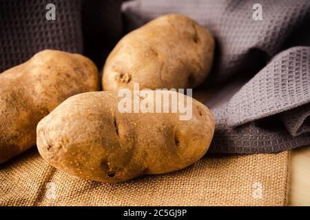 Fresh Potatoes on a rag with dark background Stock Photo - Alamy