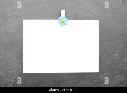 Chit and wooden peg on slate board Stock Photo - Alamy