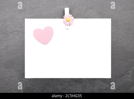 Chit and wooden peg on slate board Stock Photo - Alamy