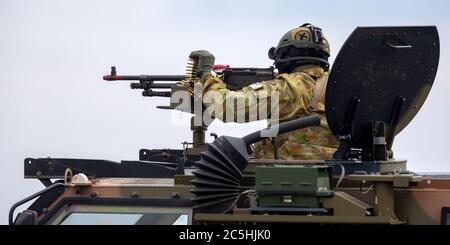 Australian soldier in camouflage, with machine gun in the Australian ...