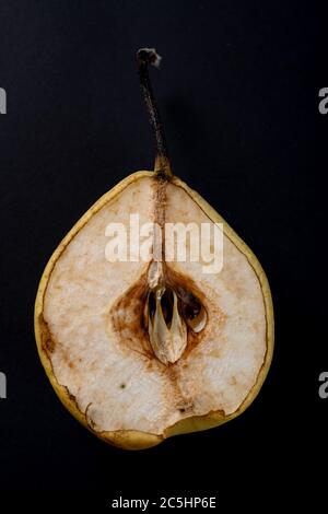 cut out section of an overripe pear on black background Stock Photo - Alamy