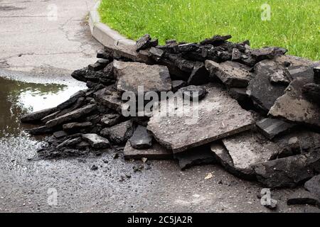 Pieces of asphalt after repair on the road Stock Photo - Alamy