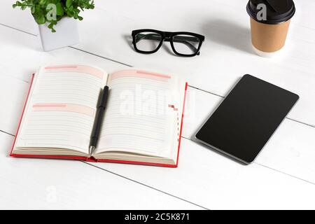 Stylish minimalistic workplace with tablet and notebook and glasses in ...
