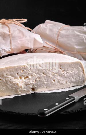 Caucasian suluguni round dairy cheese piece Stock Photo - Alamy