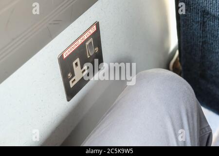 Shallow focus of a UK electrical wall outlet socket located in a ...