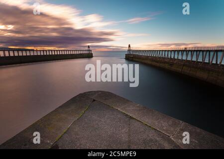 View to Whitby Harbour at sunset from the 199 steps leading from The ...