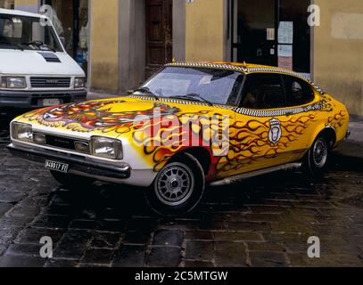 A Ford Capri, customised in flaming red and yellow and with rooftop ...