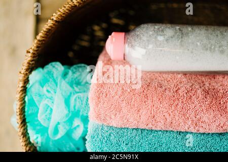 Stack of towels, soap, washcloth, gel. Stack of bath towels on wooden ...