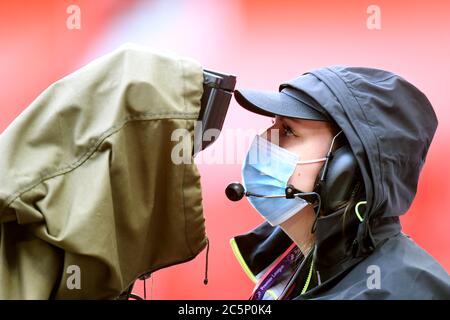 A TV camera man wearing a mask covers a UFC 249 mixed martial art bout ...