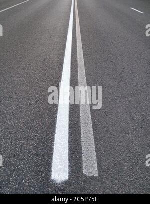 Markings on the road - The double solid line Stock Photo - Alamy