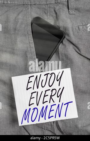 Writing note showing Enjoy Every Moment. Business concept for being ...