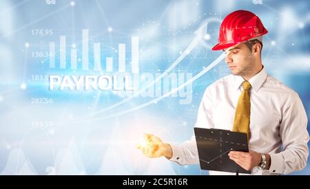 Young businessman with helmet drawing PAYROLL inscription, modern ...