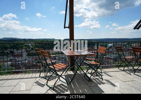 Benches and chairs at tables invite you to relax and unwind Stock Photo ...