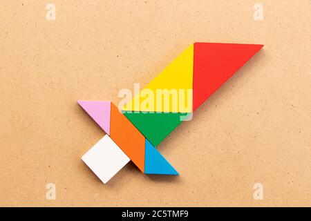 Color tangram puzzle in sword shape on wood background Stock Photo - Alamy