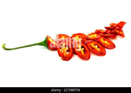 Sliced red hot pepper folded in the shape of pepper on a white ...