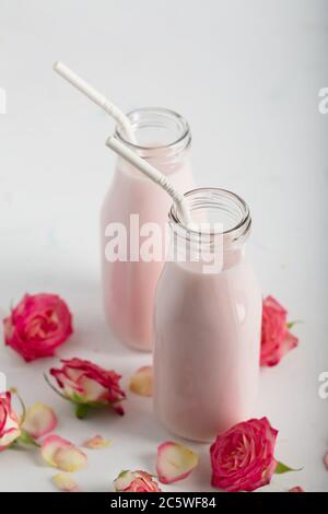 Rose moon milk in two cups on the pink surface. Location vertical Stock ...