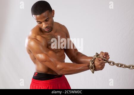 Strong black man with a chain around his wrist Stock Photo - Alamy