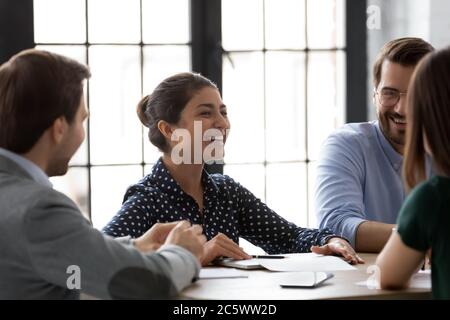 Friendly colleagues laughing during briefing in office Stock Photo - Alamy