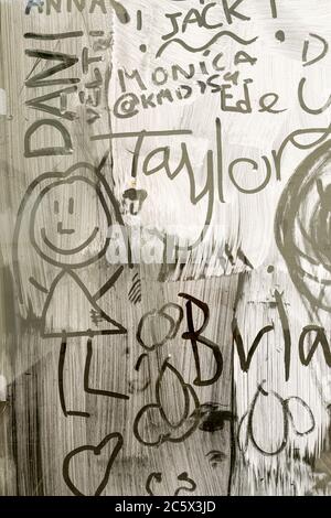 Drawings and writings on window whitewash paint creates an abstract ...