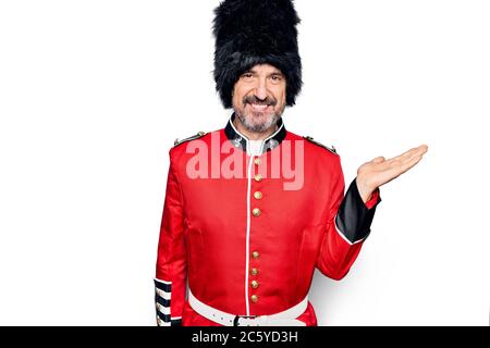 Middle age handsome wales guard man wearing traditional uniform over ...