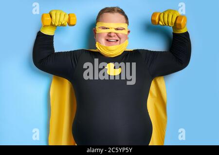 fat caucasian powerful superhero man show how strong he is, man holds ...