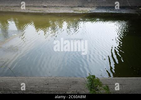 stream flowing through concrete embankment Stock Photo - Alamy