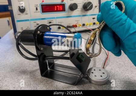 Geiger counter measuring radioactivity from a rock in a science museum ...