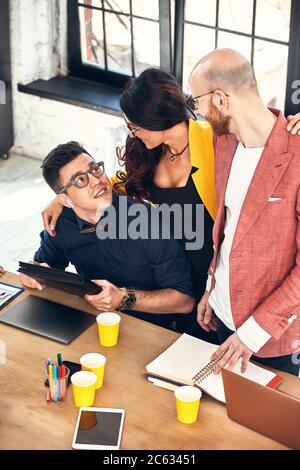 Cheerful friendly programmers smiling while working together Stock ...