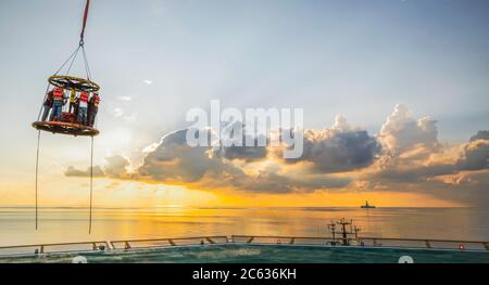Offshore Oil Platform personnel crew change boarding helicopter on oil ...