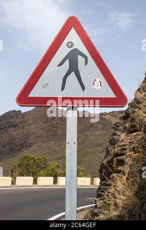 A road sign defaced with stickers, on a road by the sea Stock Photo - Alamy