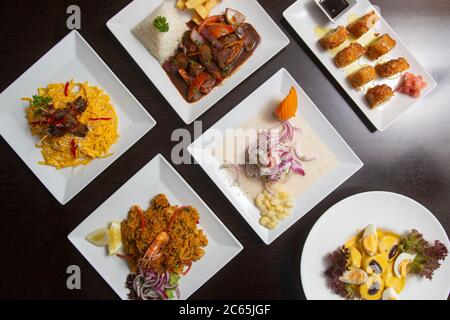 Typical Peruvian food seen from above on dark wooden table Stock Photo ...