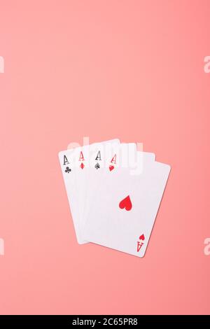 Expanded playing cards on pink background Stock Photo - Alamy