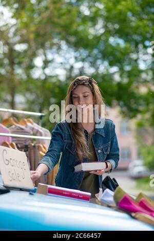 Pretty young woman reading interesting book in autumn park Stock Photo ...