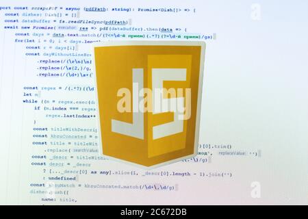 Moscow, Russia - 1 June 2020: JavaScript JS logo sign with program code ...