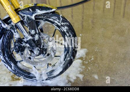 cleaning of the motorcycle at the car wash by water and foam Stock ...