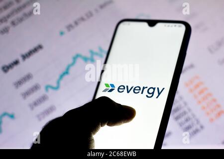 In this photo illustration the evergy logo seen displayed on a ...
