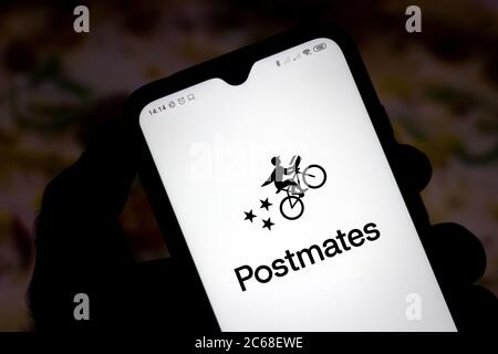 In this photo illustration, the Postmates logo is seen displayed on a ...