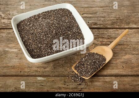 Wooden bowl of chia seeds and wooden shovel on wood Stock Photo - Alamy