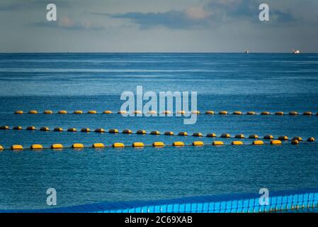 Yellow buoyancy on the beach, sign warning dangerous Stock Photo - Alamy