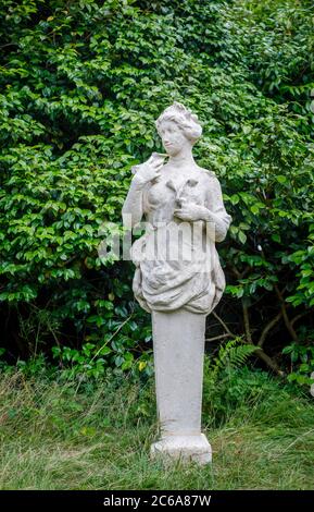 Classical slightly eroded vintage stone statue of a female nymph or ...